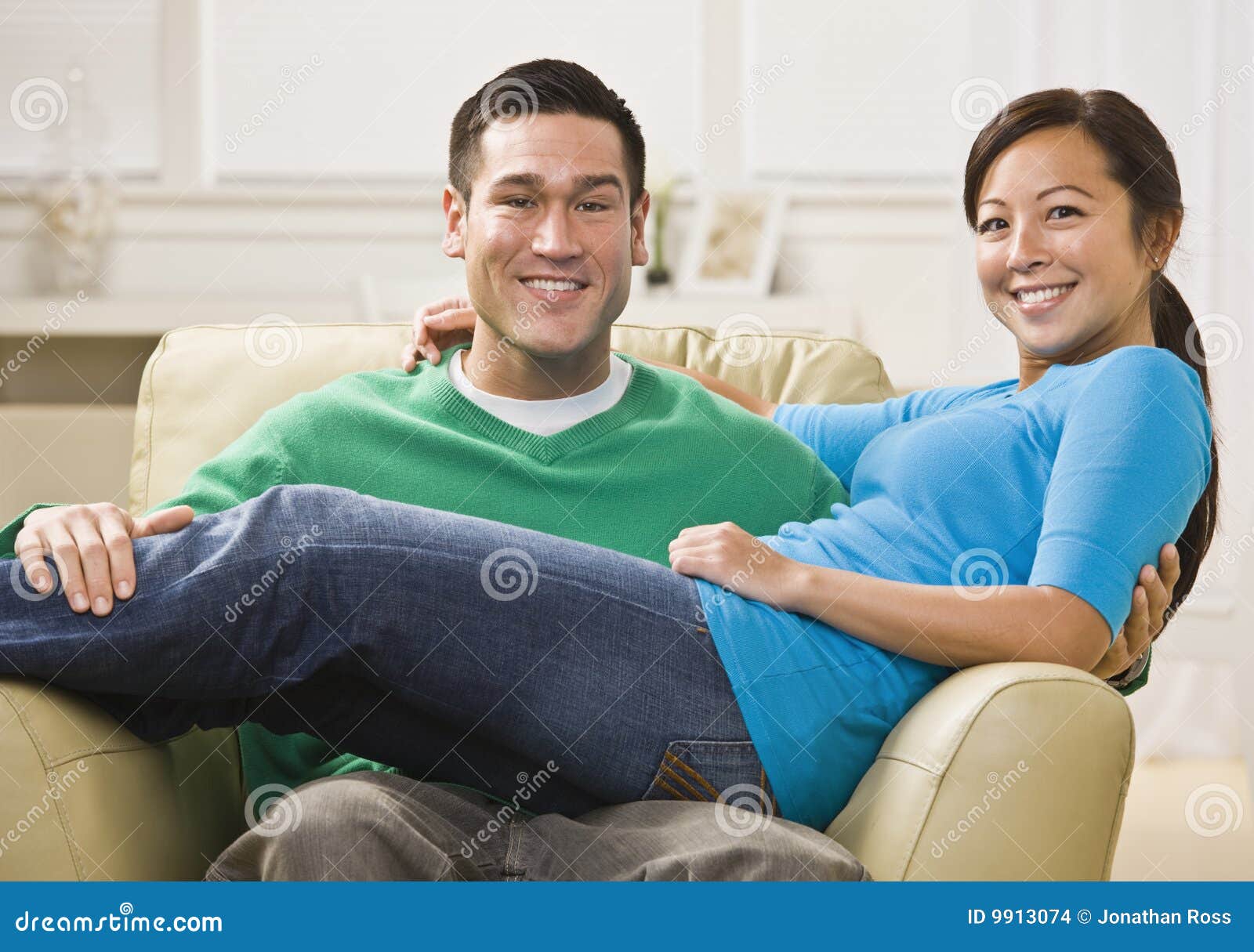 Attractive Smiling Couple on Sofa Stock Photo - Image of beautiful ...