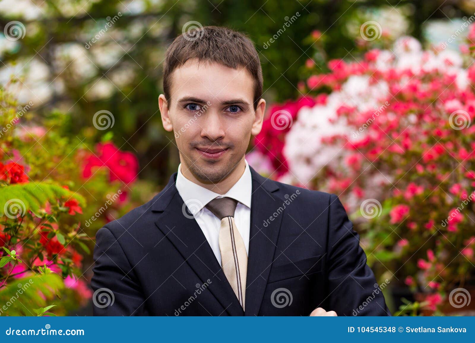 Attractive Smiling Young Men in a Business Suit in a Flower Garden ... Attractive Smiling Young Men in a Business Suit in a Flower Garden ...