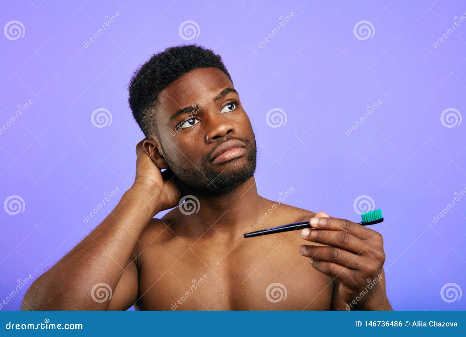 Attractive Thoughtful Guy is Standing with Brush for Teeth Stock Photo ...