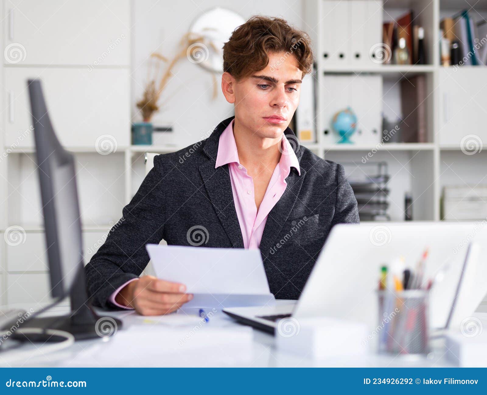 Attractive Thoughtful Young Man Working with Documents Stock Photo ...