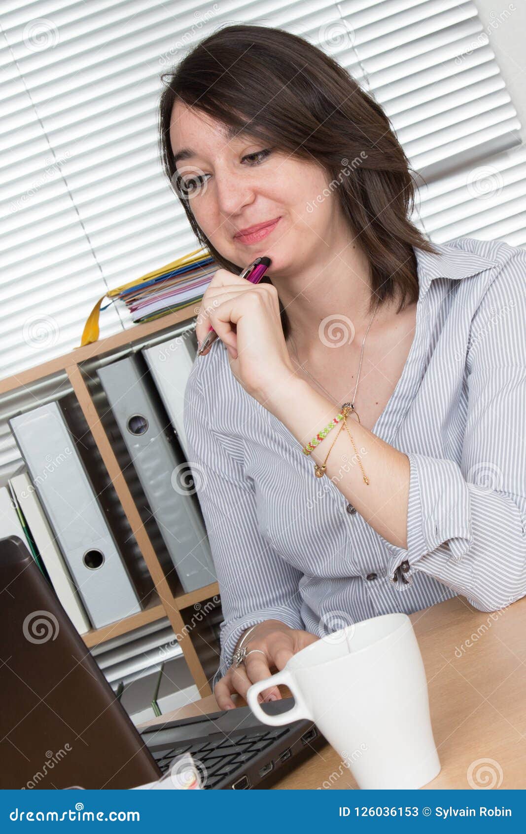Attractive Woman at Modern Office Desk Working with Laptop Looking at ...