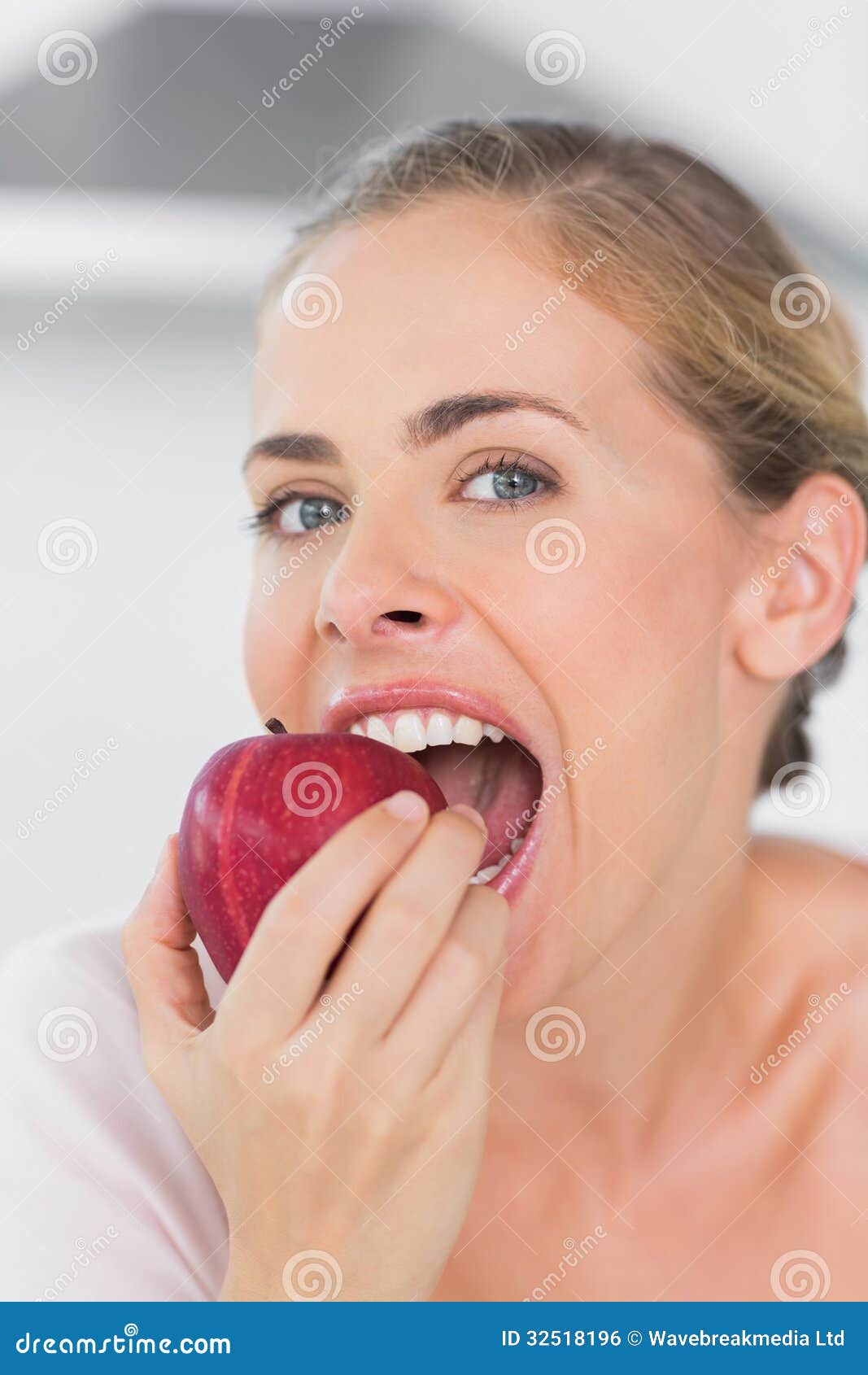 Attractive Woman Munching Red Apple Stock Photo - Image of house ...