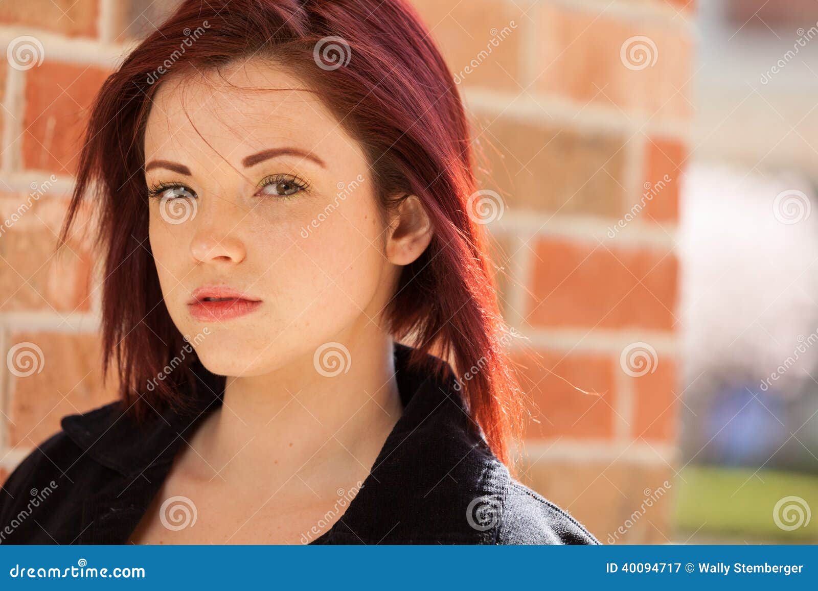 Attractive Woman Posing in Front of a Red Brick Wall Stock Image ...