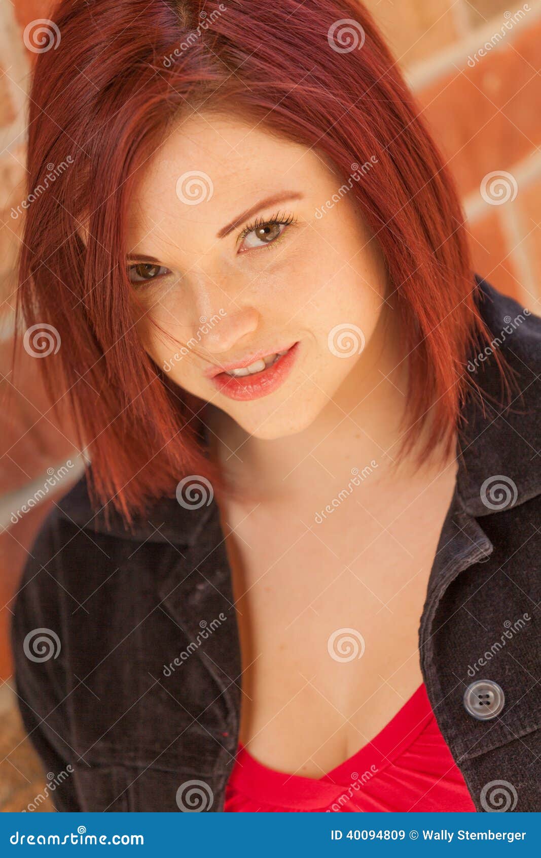 Attractive Woman Posing in Front of a Red Brick Wall Stock Image ...