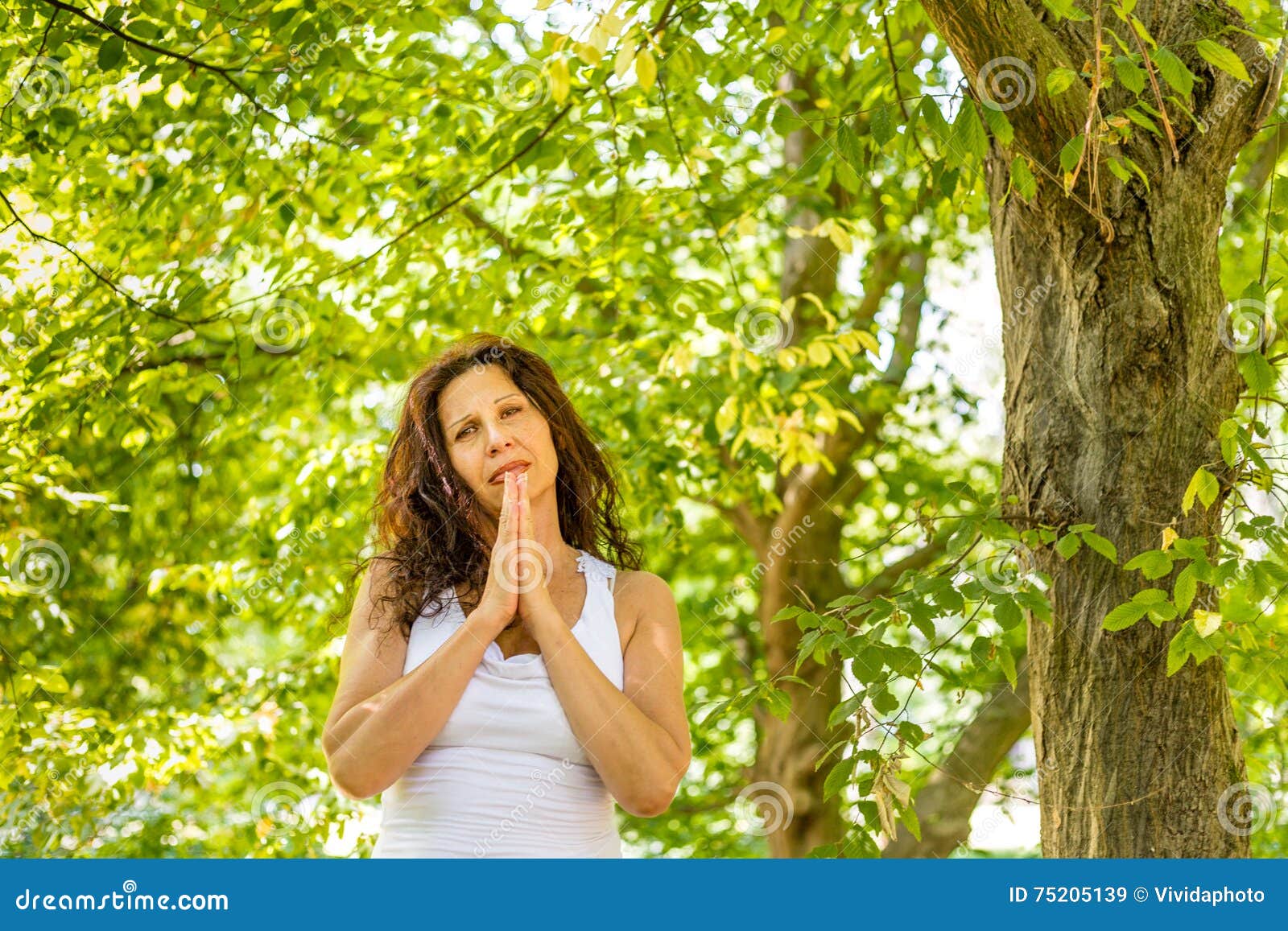 Attractive woman praying stock image. Image of clasped - 75205139