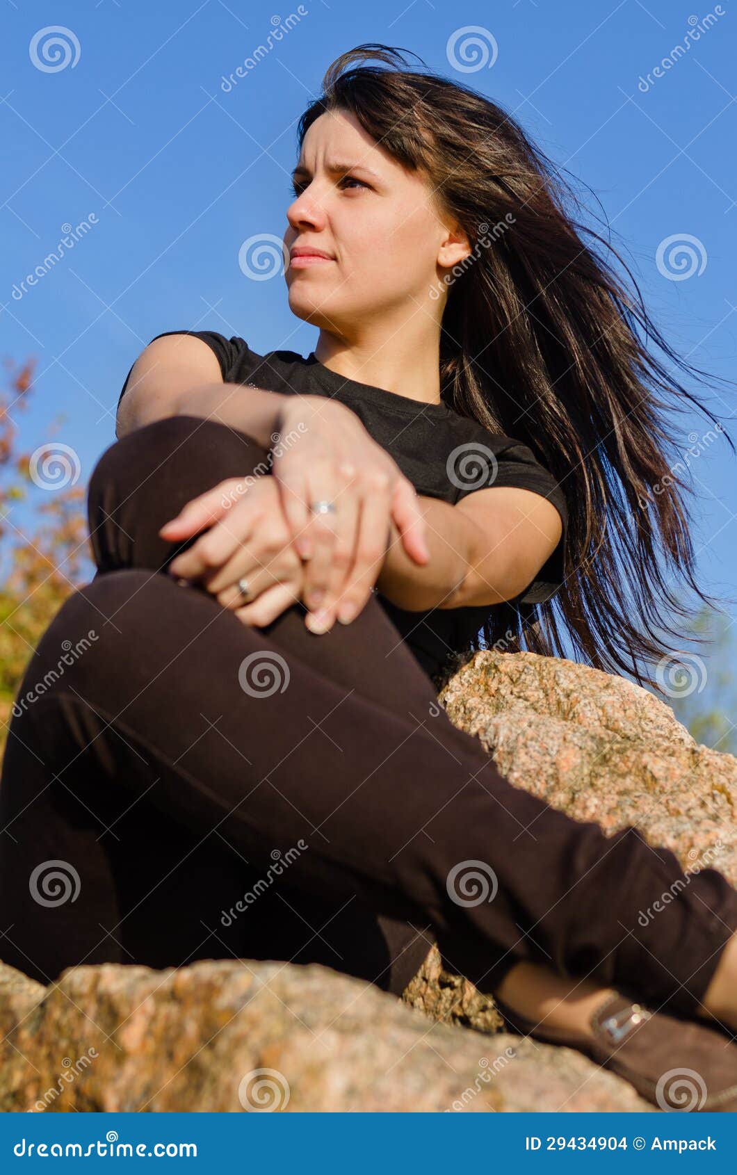 Attractive Woman Sitting on a Rock Stock Photo - Image of rock, person ...