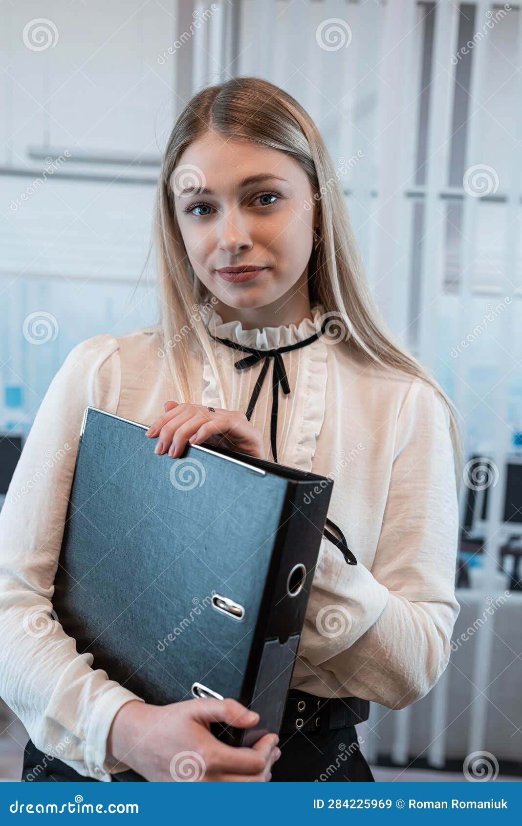 Attractive Woman Standing Alone at the Office and Hold Folder for Paper ...