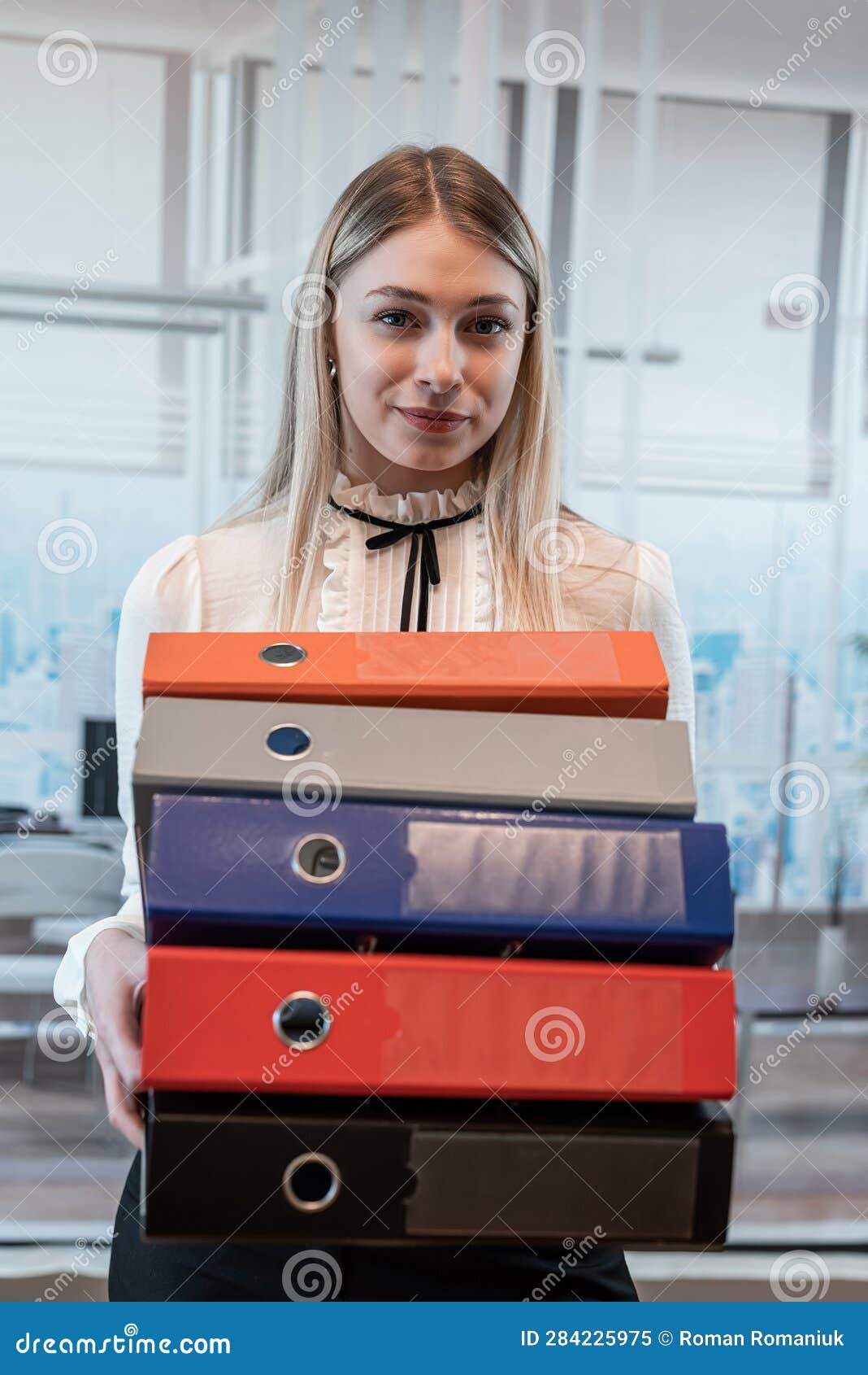 Attractive Woman Standing Alone at the Office and Hold Folder for Paper ...