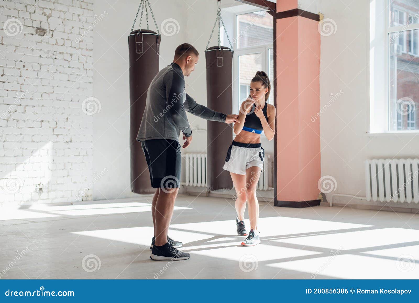 An Attractive Young Boxer Teaches His Girlfriend Boxing Techniques in a ...