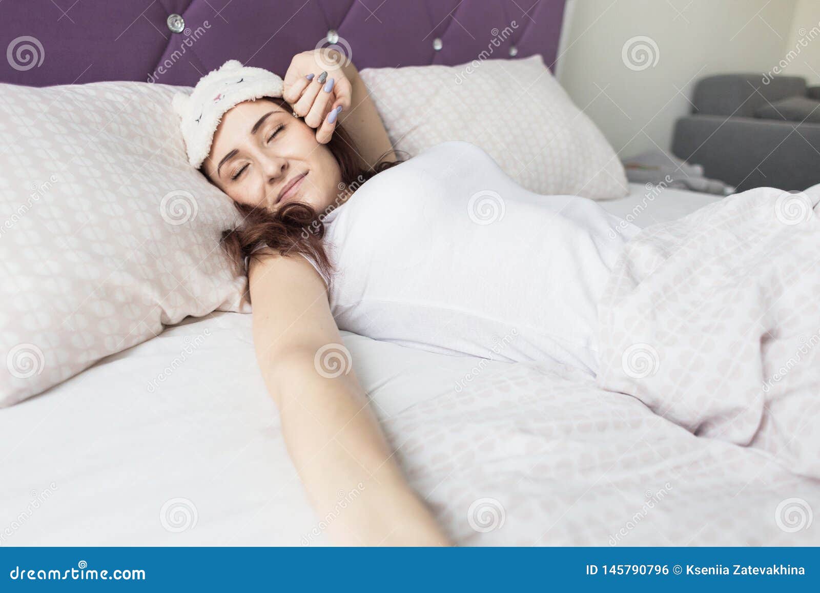 An Attractive Young Brunette Woman Wakes Up In Her Bed In A Sleep Mask