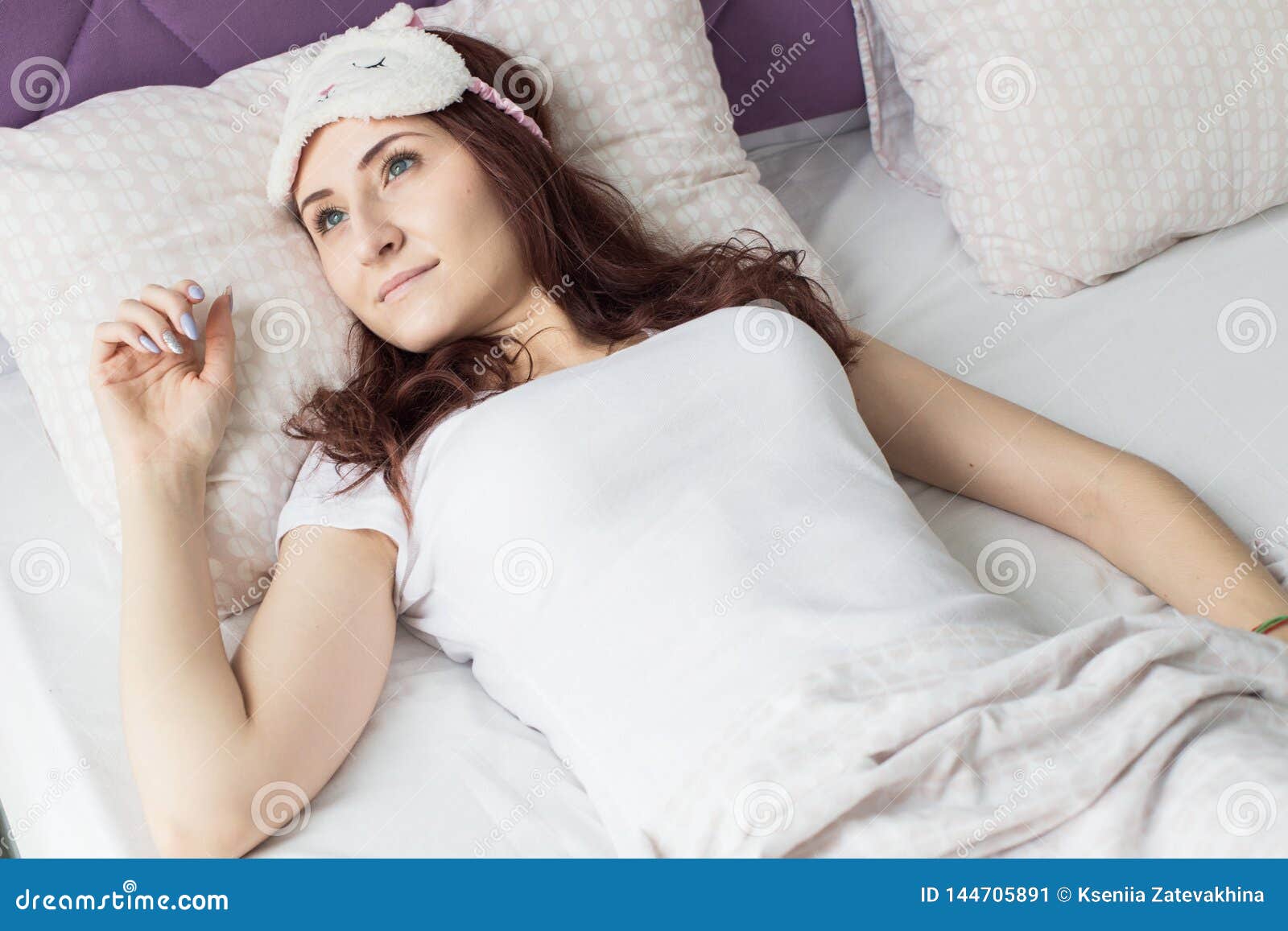 An Attractive Young Brunette Woman Wakes Up In Her Bed In A Sleep Mask