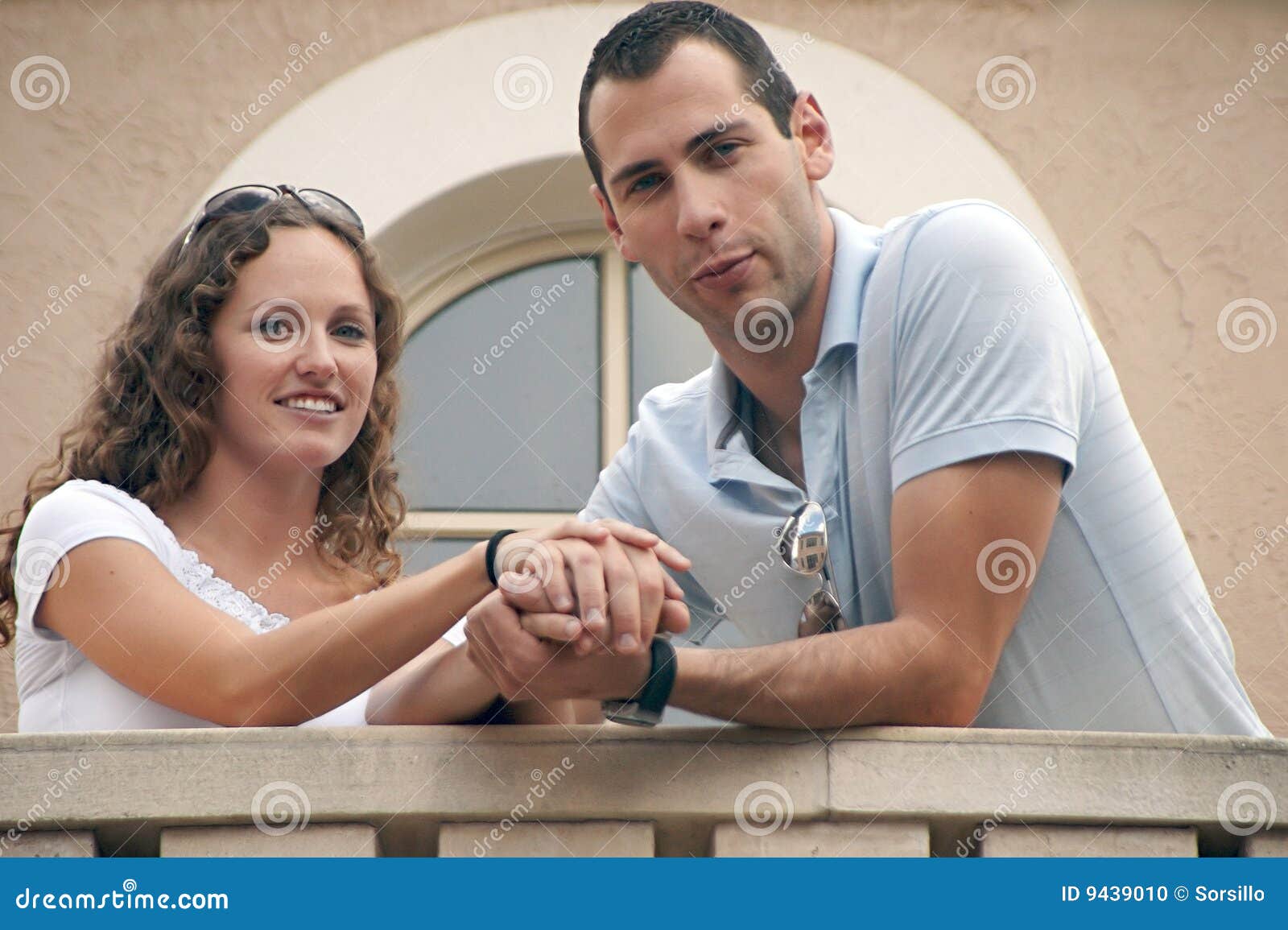 Attractive Young Couple Holding Hands on Balcony Stock Photo - Image of ...