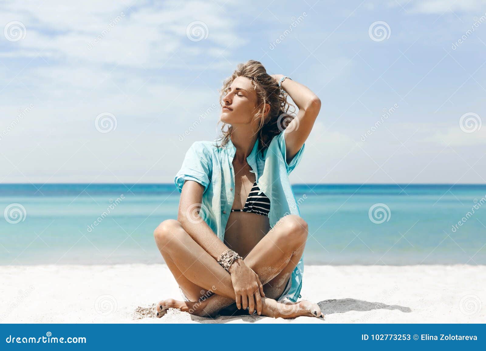Beautiful Young Cheerful Woman In Bikini Sitting On The Beach Stock