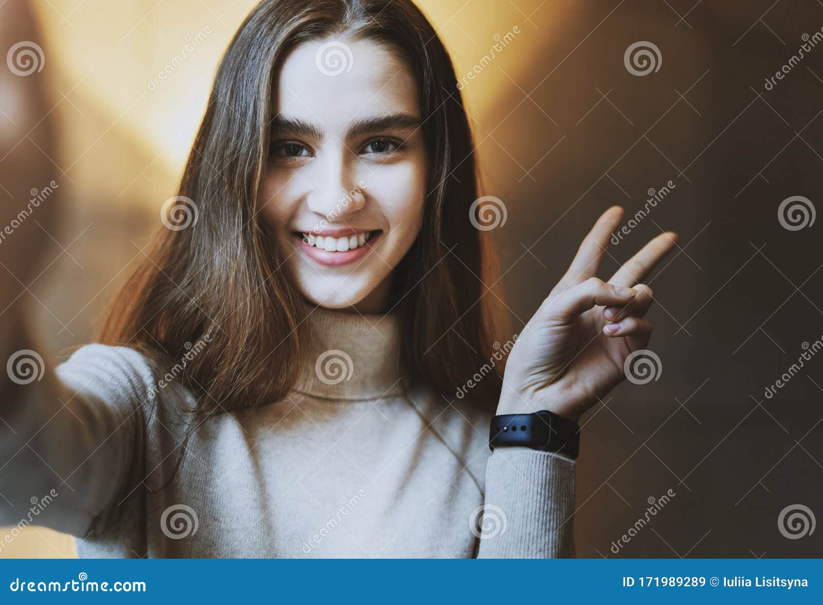 Attractive Young Female Showing Victory Sign On Picture Model Posing