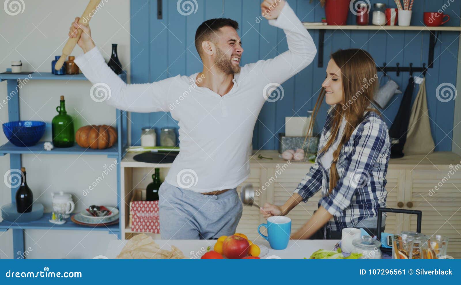 Young Joyful Couple Have Fun Dancing and Singing while Set the Table ...