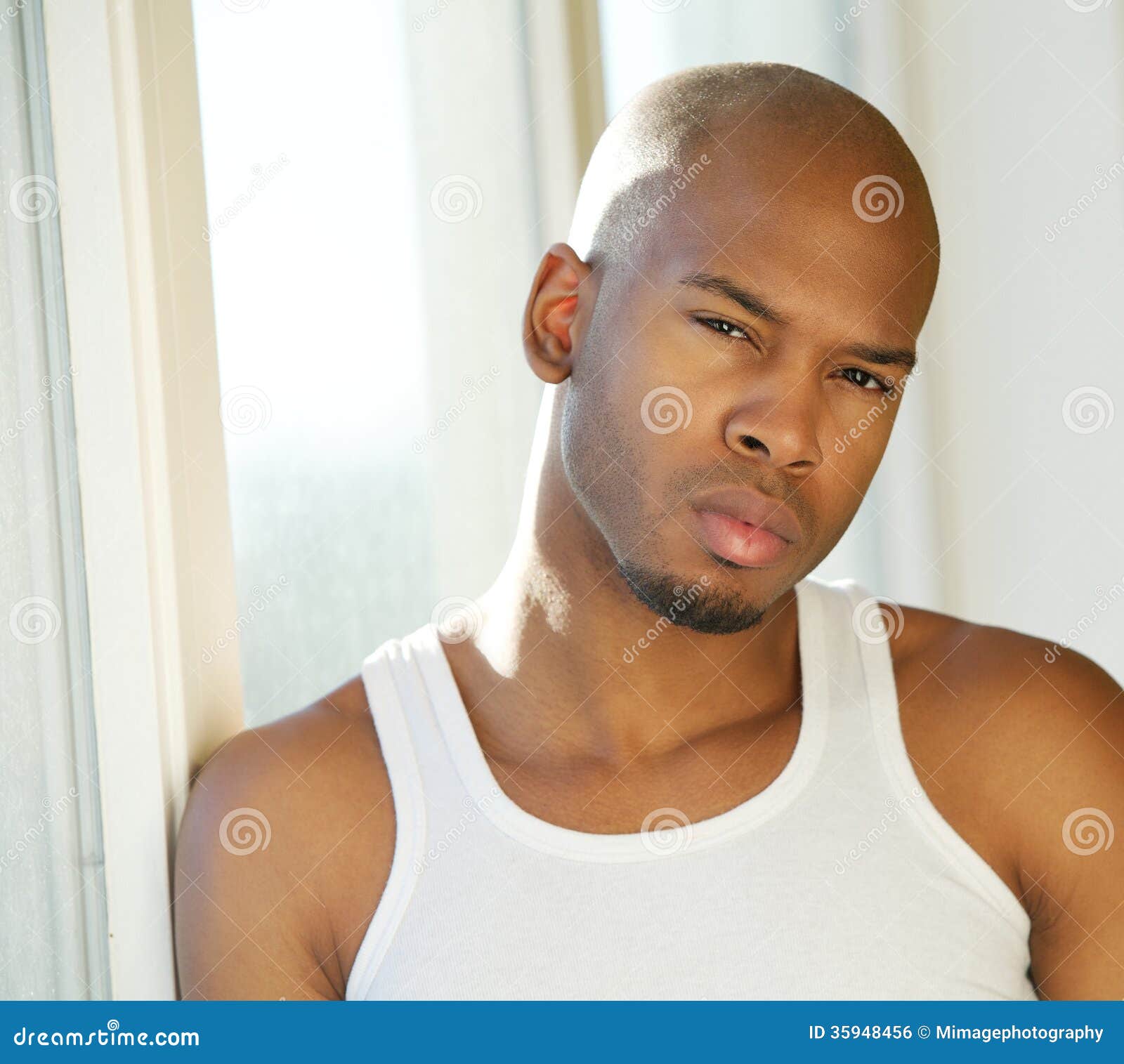 Attractive Young Man Posing by Window at Home Stock Photo - Image of ...