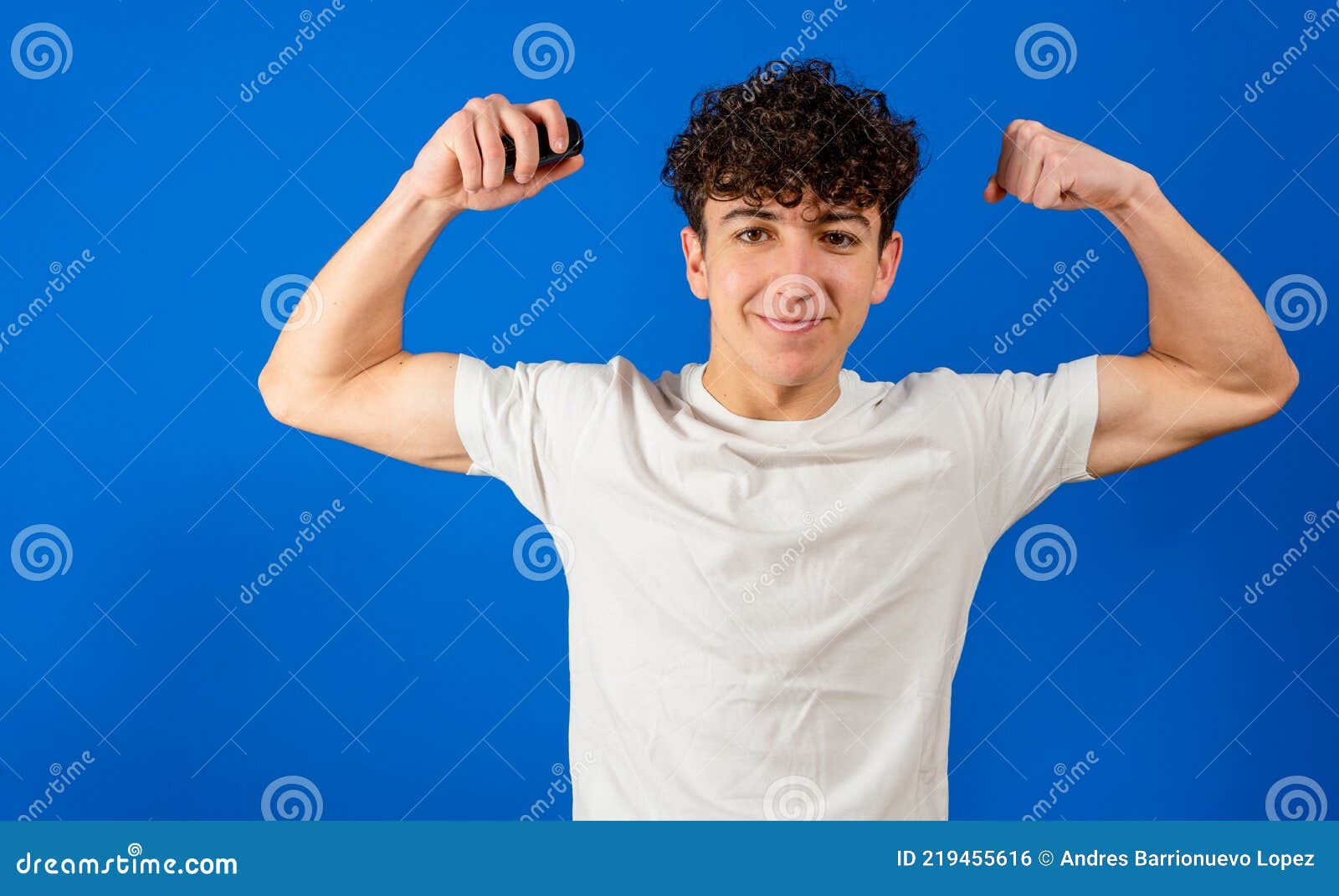 Attractive Young Man Pulling Out Muscles while Looking Smiling at the ...