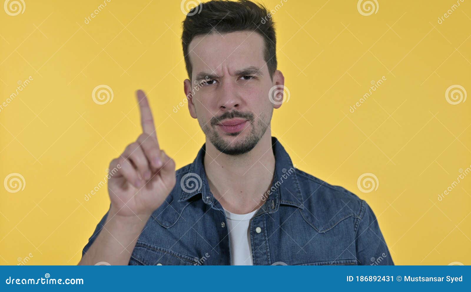 Attractive Young Man Saying No by Finger, Yellow Background Stock Image ...