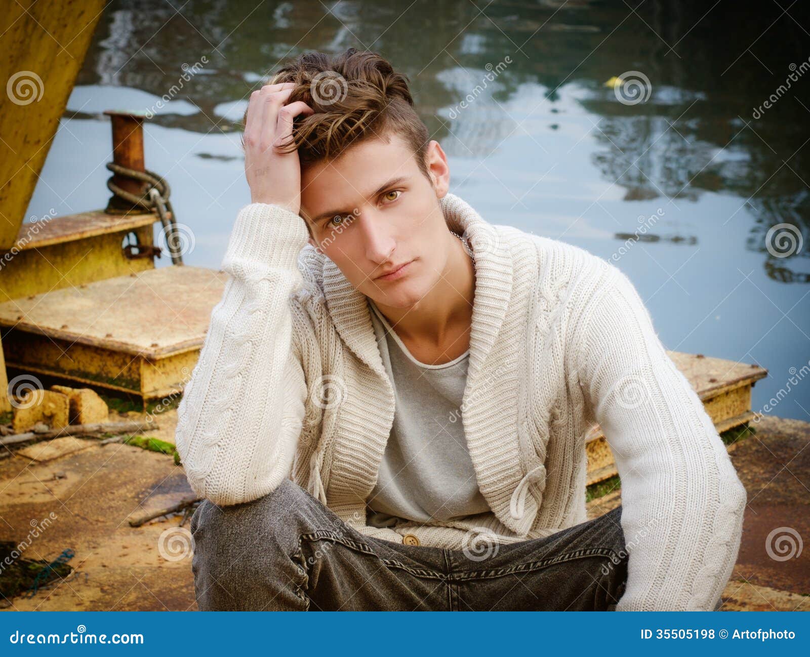 Attractive Young Man Sitting on Rusty Metal Stock Photo - Image of ...