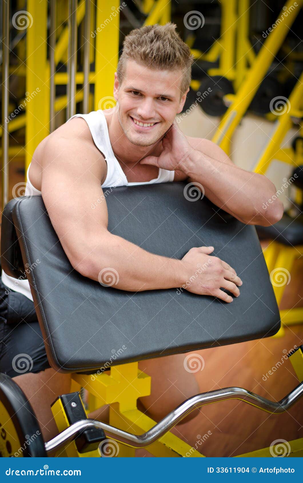 Attractive Young Man Smiling on Gym Equipment Stock Photo - Image of ...