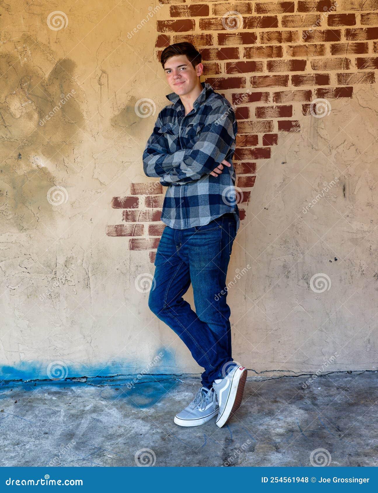 Attractive Young Man Standing in Front of Brick Wall Stock Photo ...