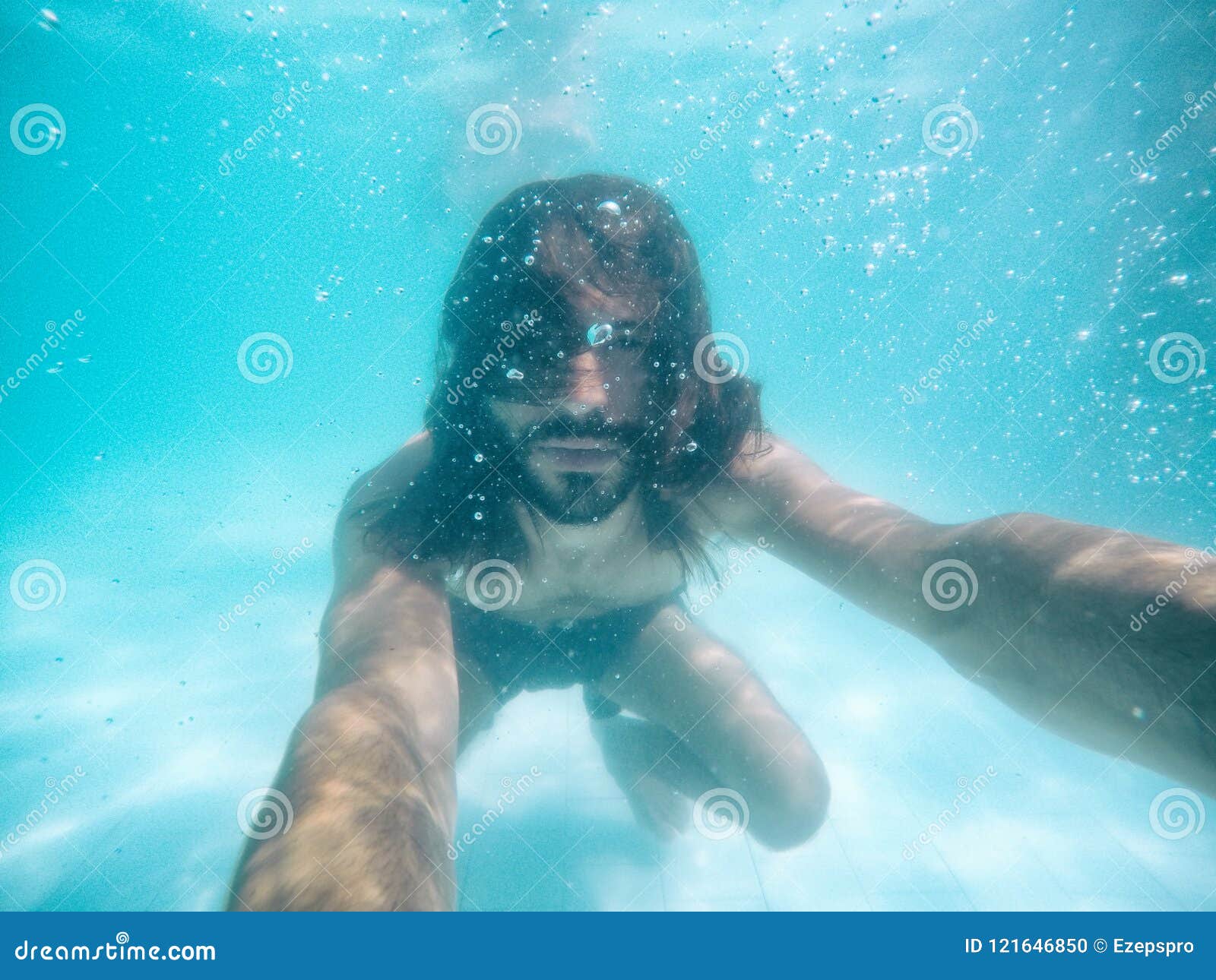 Attractive Young Man Submerged in Pool Looking at Camera Stock Photo ...