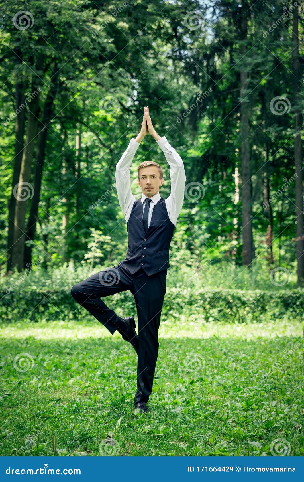Attractive Young Man in a Suit Does Yoga Tree Pose in a Park Stock ...