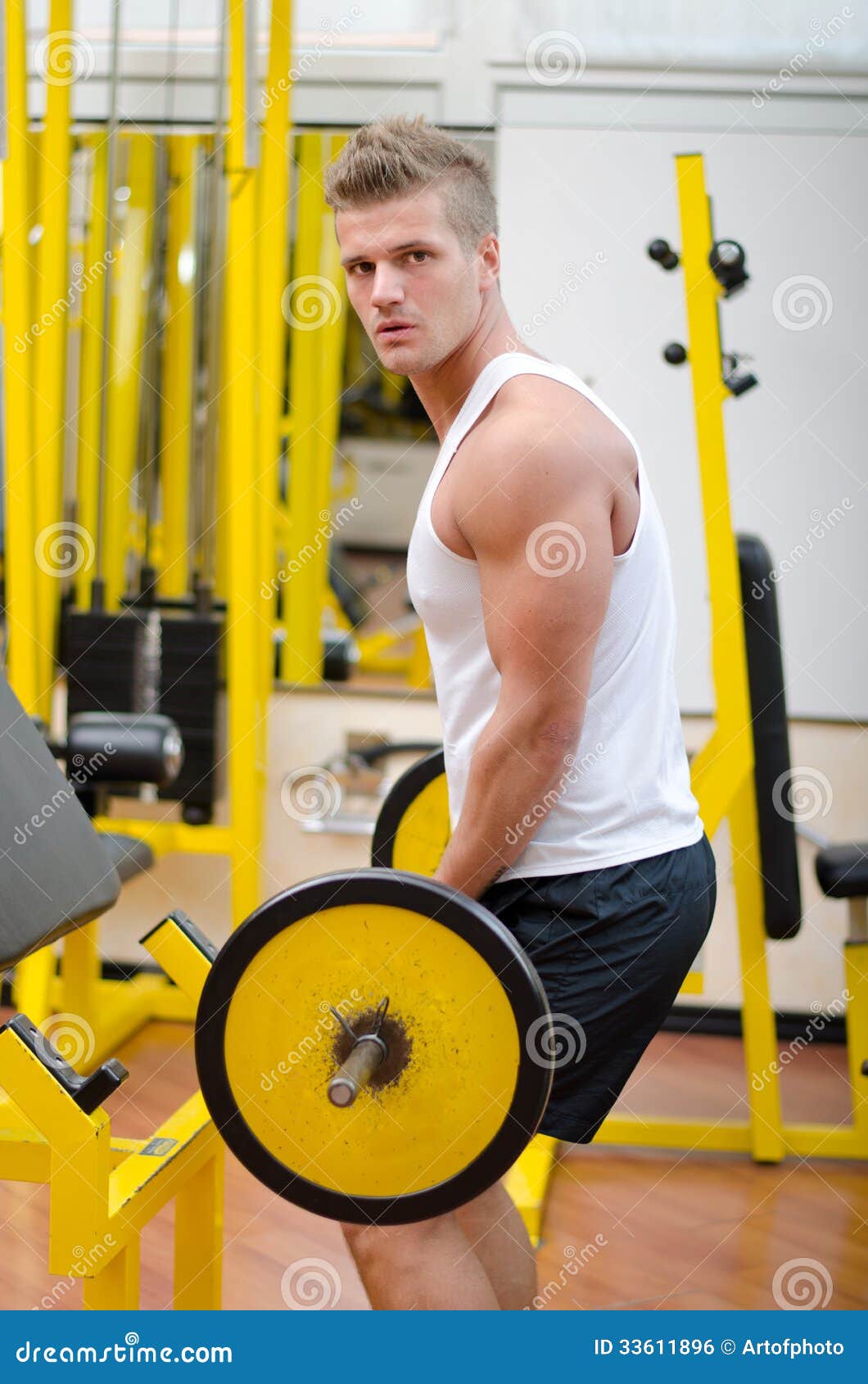 Attractive Young Man Working Out with Barbell at Gym Stock Photo ...