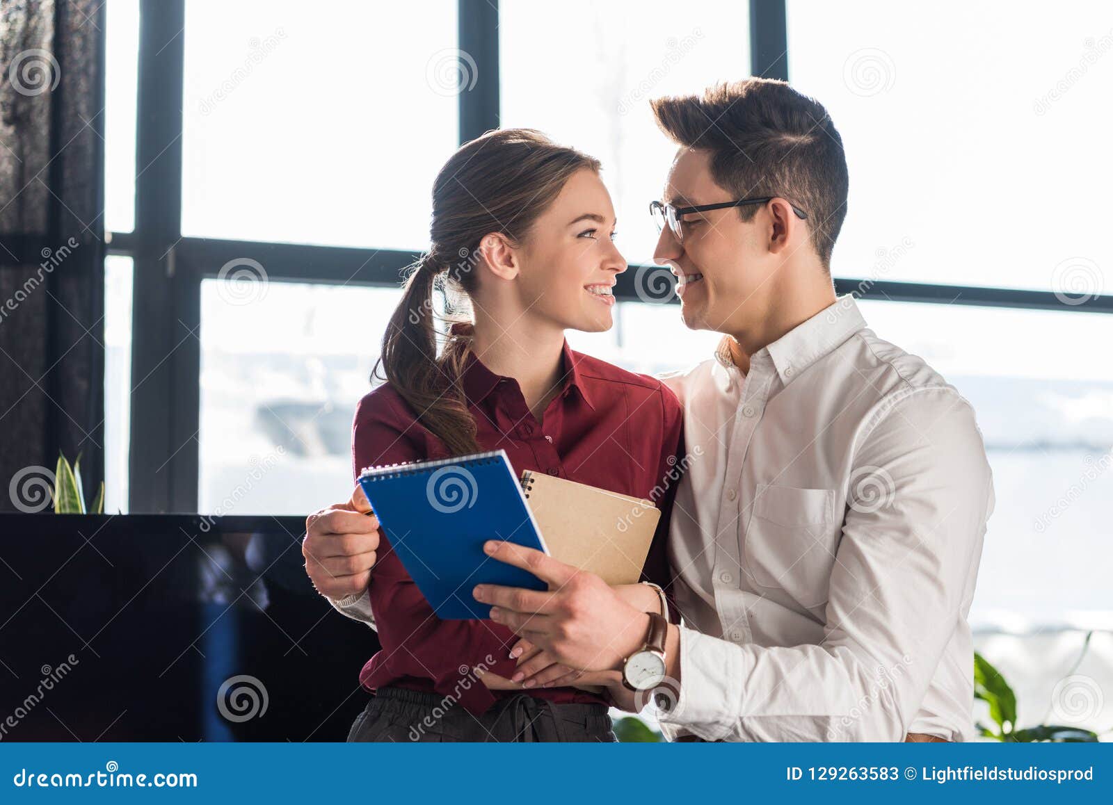 Attractive Young Managers Couple Embracing at Office Workplace Stock ...