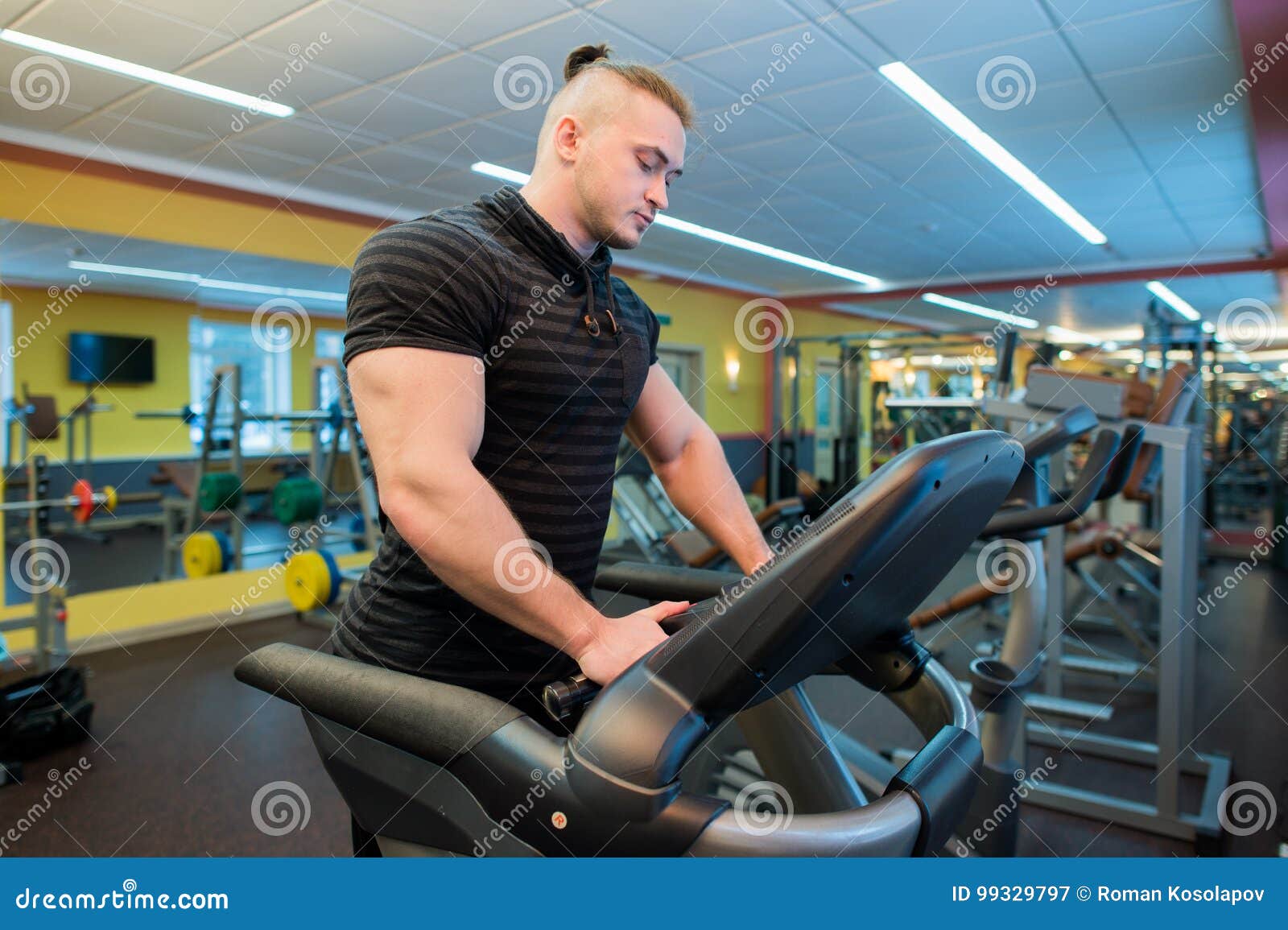 Attractive Young Muscular Man while Running on a Treadmill in Gym Stock ... Attractive Young Muscular Man while Running on a Treadmill in Gym Stock ...