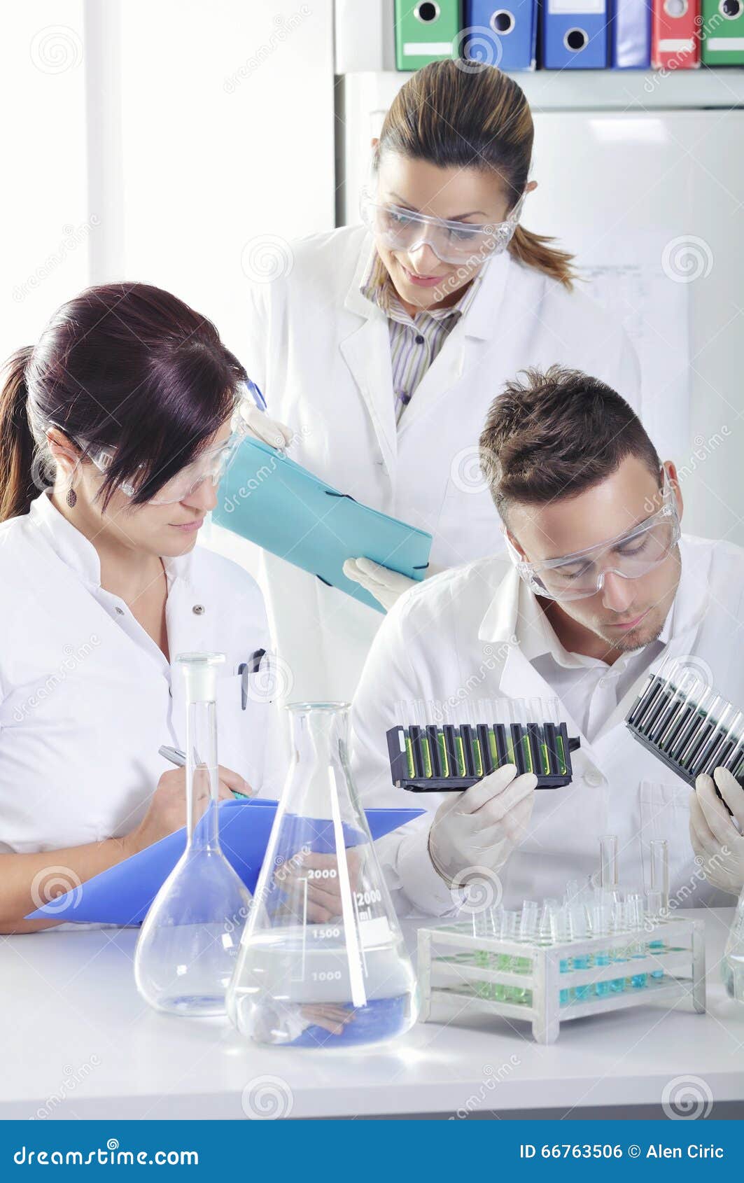 Two Scientists Observing Something With Microscope Stock Photo ...