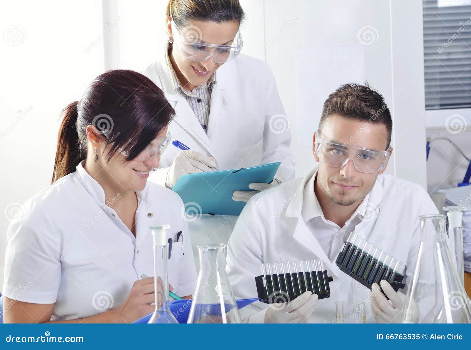 Two Scientists Observing Something With Microscope Stock Photo ...