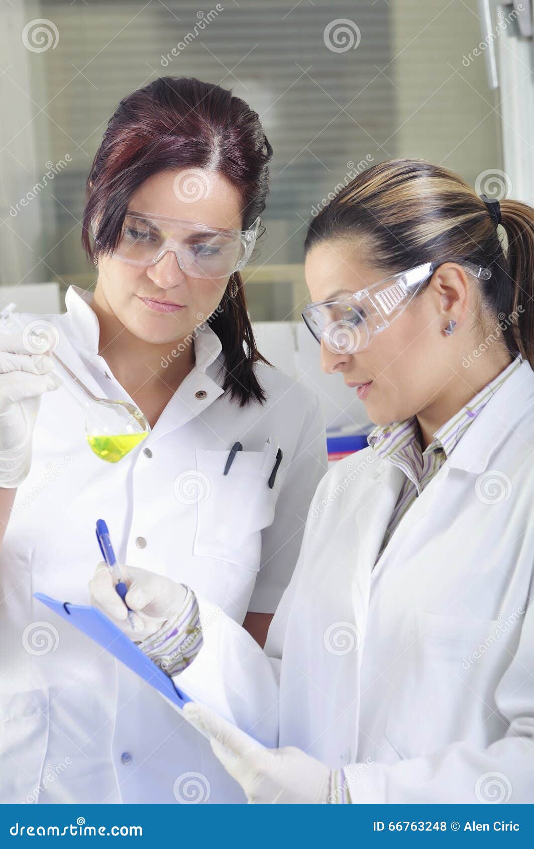 Two Scientists Observing Something With Microscope Stock Photo ...