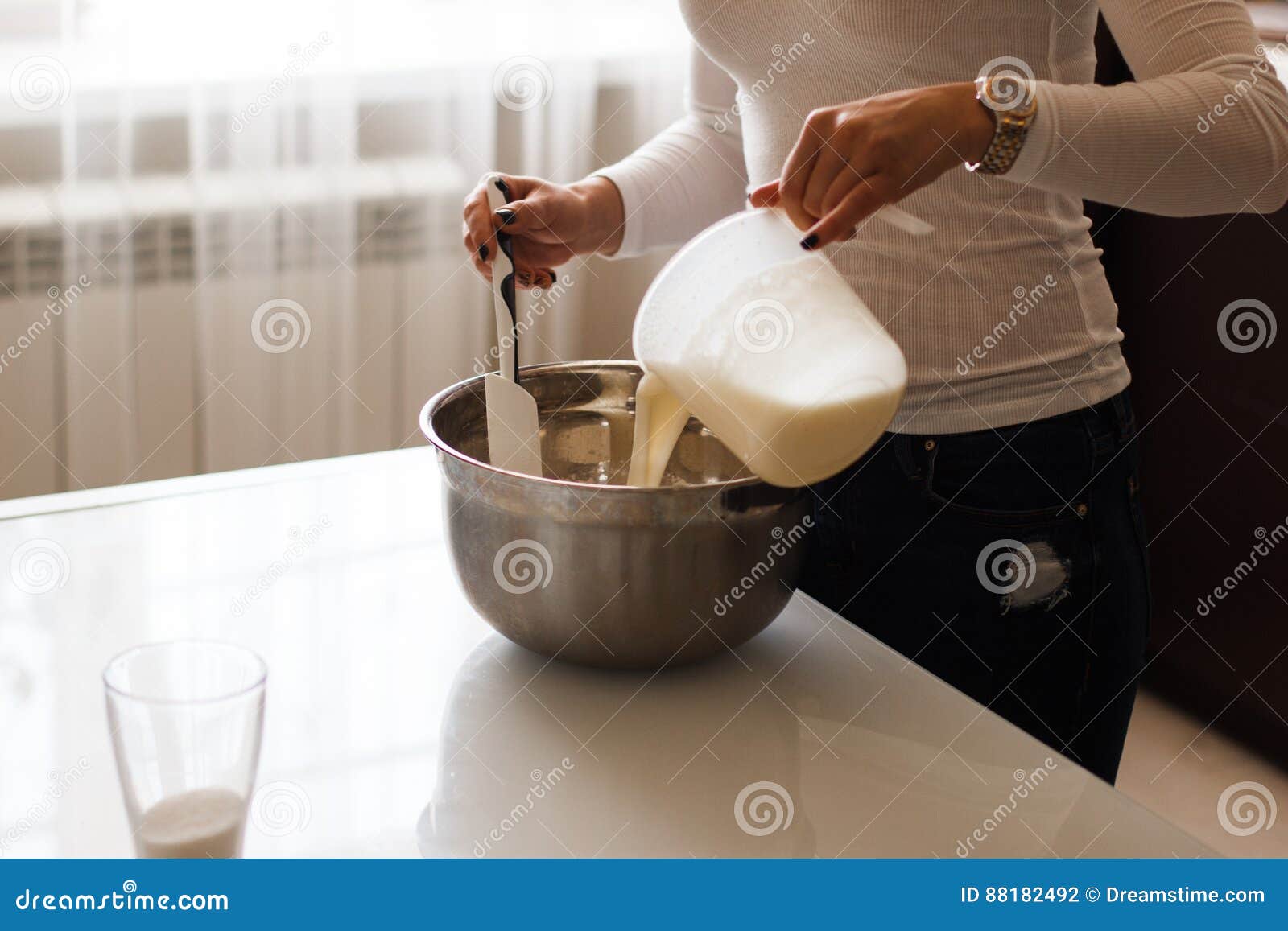 Attractive Young Woman Adding Milk To the Flour Stock Photo - Image of ...