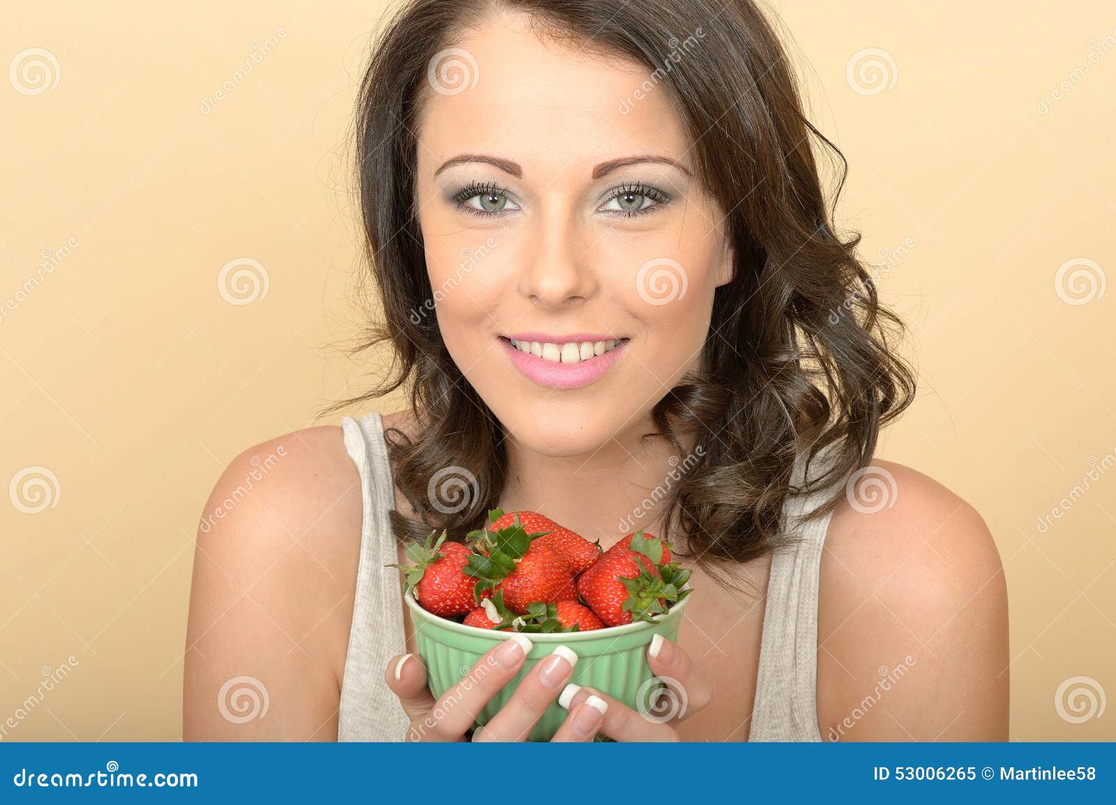Attractive Young Woman Holding A Bowl Of Fresh Ripe Strawberries Stock