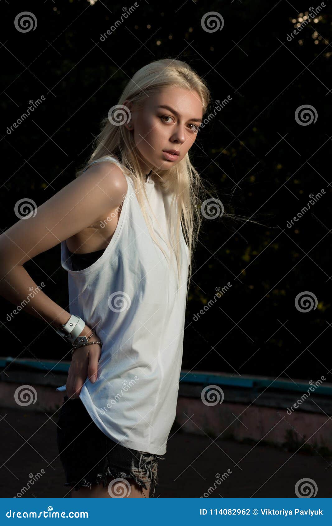 Attractive Blonde Girl With Long Hair Dressed In Fashionable Clothes