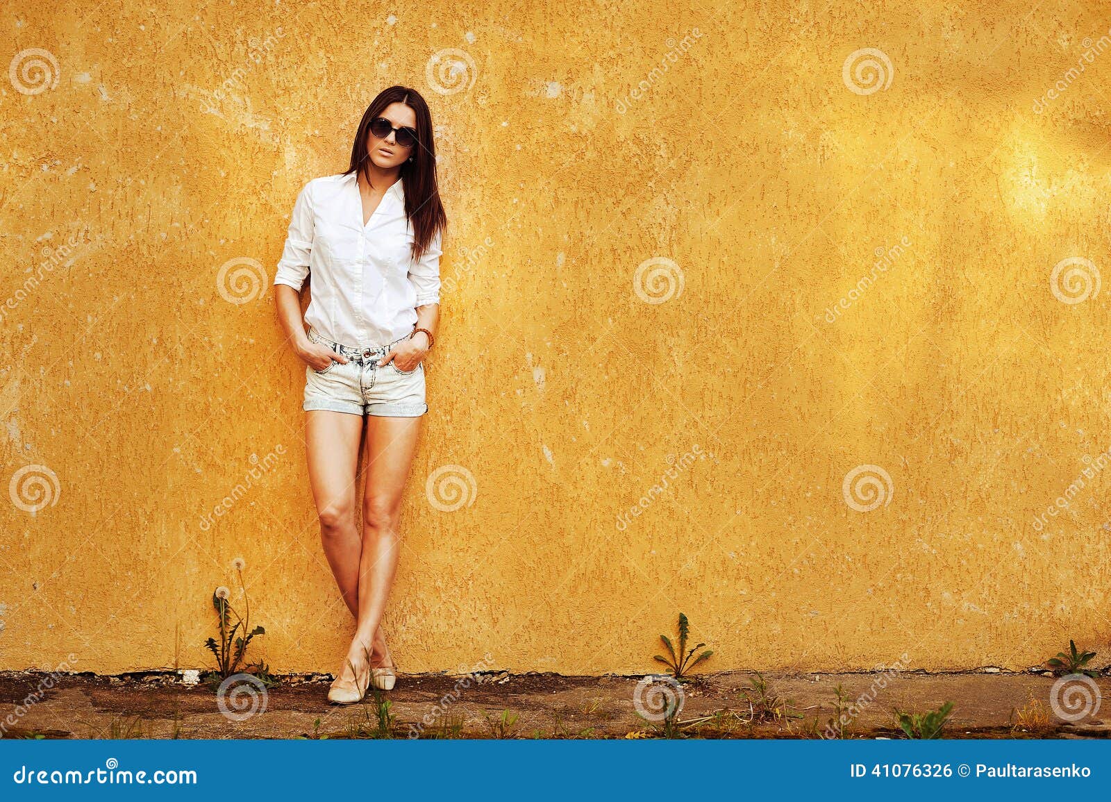 Attractive Young Woman Posing by the Wall Stock Photo - Image of jeans ...