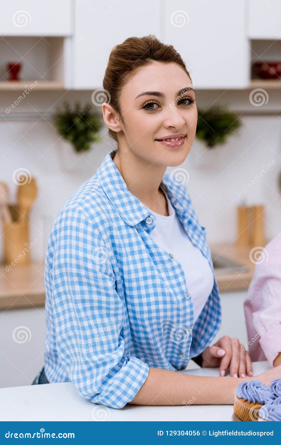 Attractive Young Woman Sitting at Kitchen and Looking Stock Photo ...