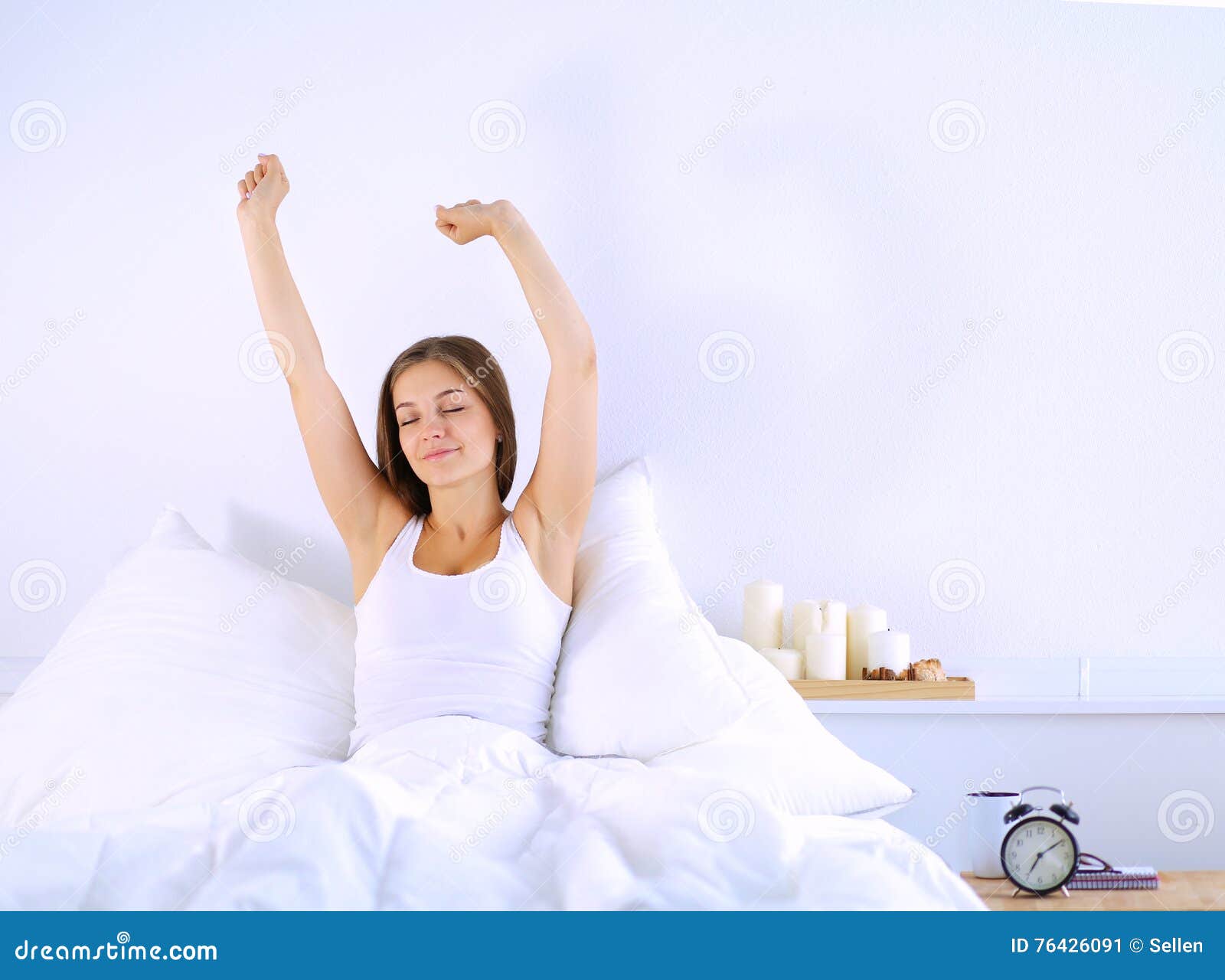 An Attractive Young Woman Stretching in Bed after Waking Up Stock Image ...