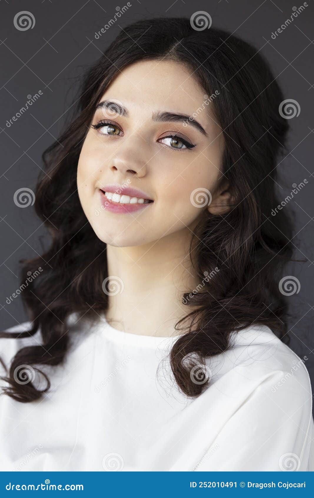Closeup Portrait Of A Smiling Young Woman Wear White Shirt Looking At