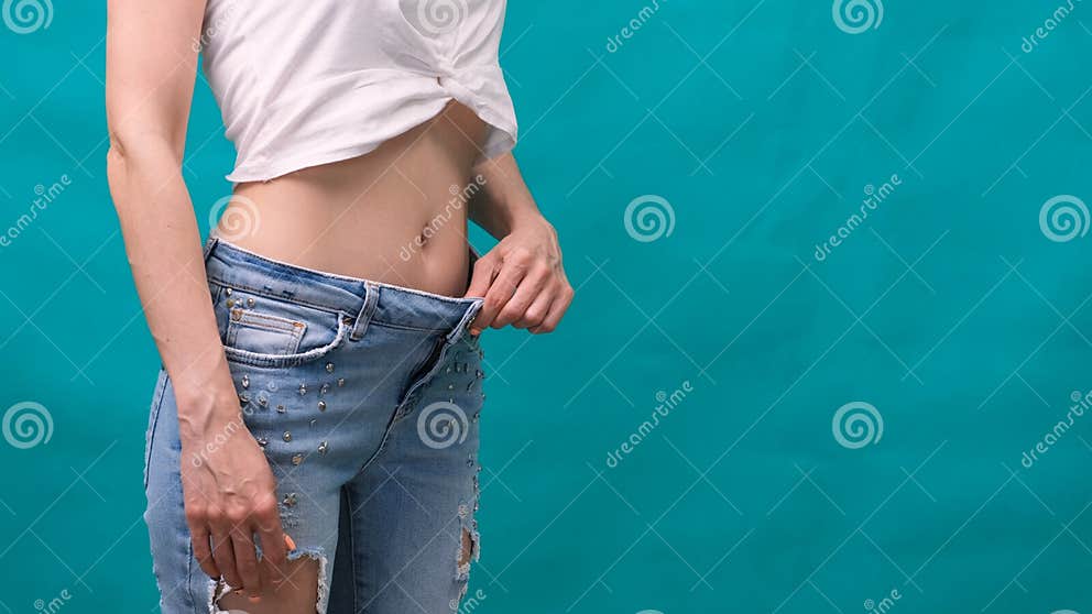 Attractive Young Woman Wearing Jeans And Showing Slim Body After Sport