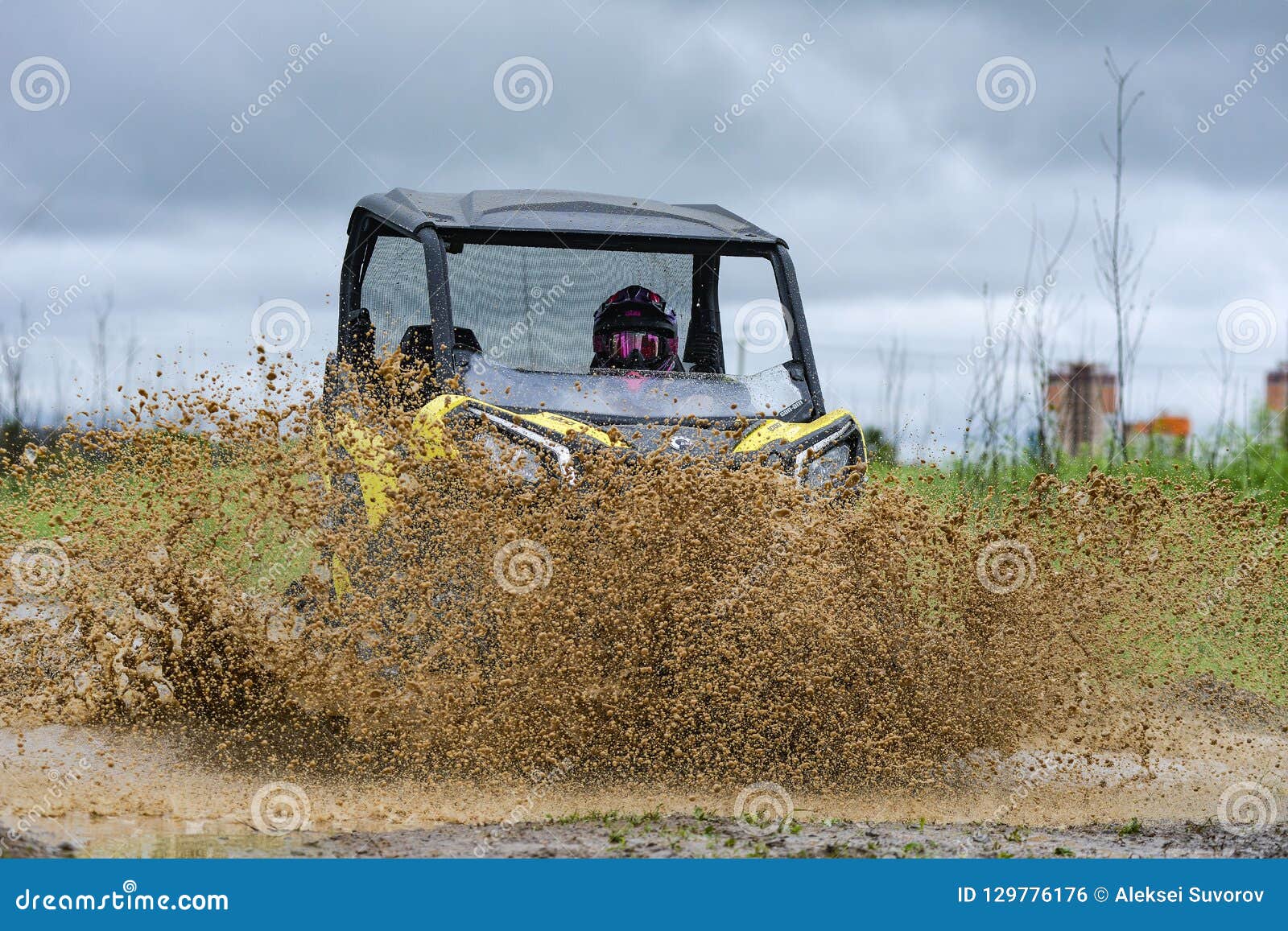 ATV Brp is Moving on a Muddy Puddle Making Splashes Stock Photo - Image ...