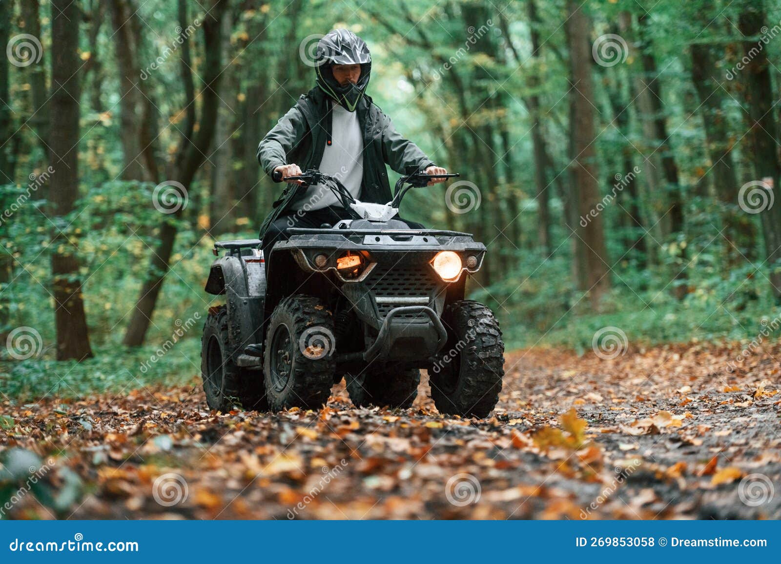 ATV Driver is in the Forest, Having a Ride at Daytime Stock Photo ...