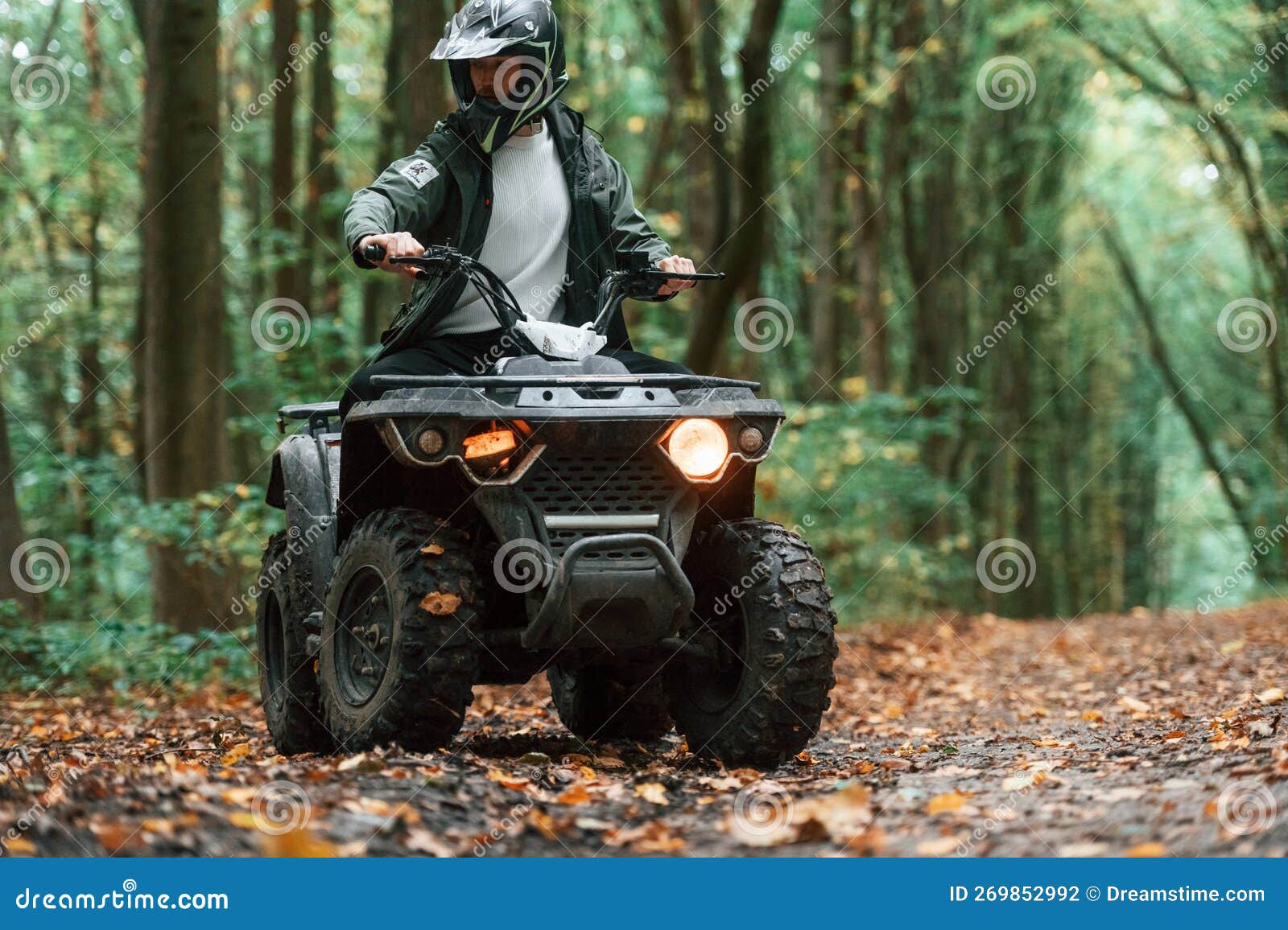 ATV Driver is in the Forest, Having a Ride at Daytime Stock Photo ...