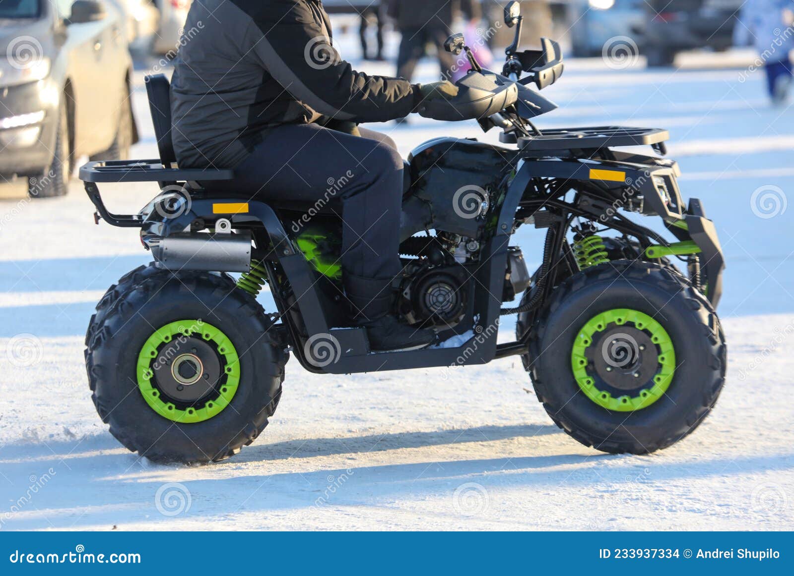 The ATV rides in the snow stock photo. Image of vehicle - 233937334