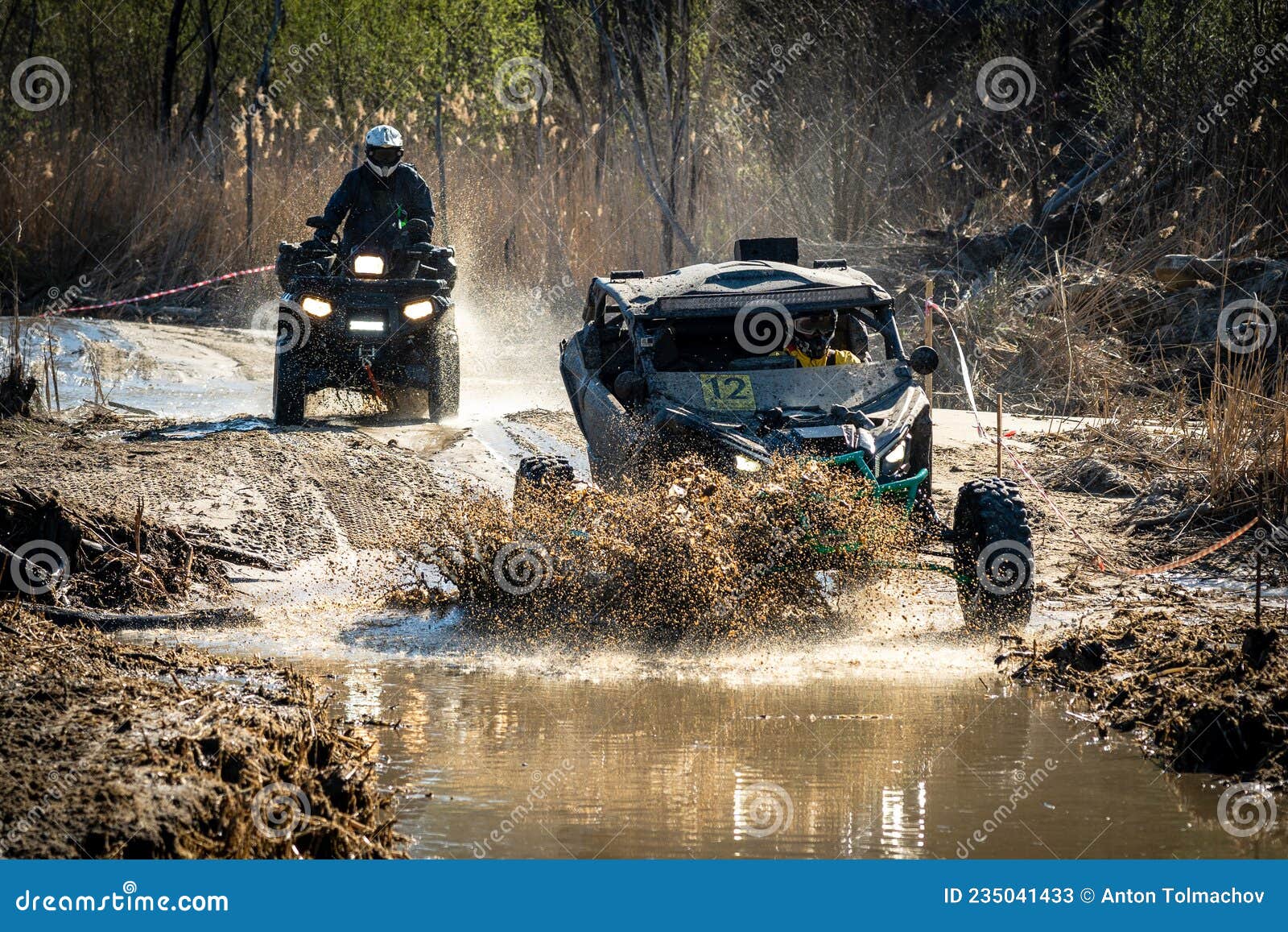 ATV and UTV Riding in Hard Track with Mud Splash. Amateur Competitions ...