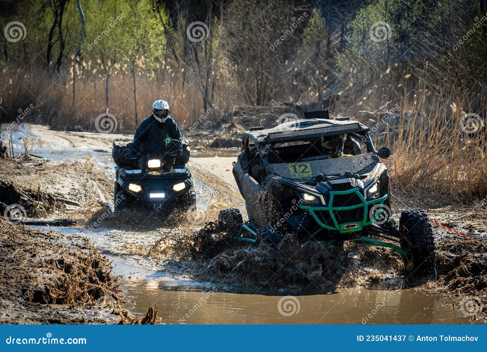ATV and UTV Riding in Hard Track with Mud Splash. Amateur Competitions ...