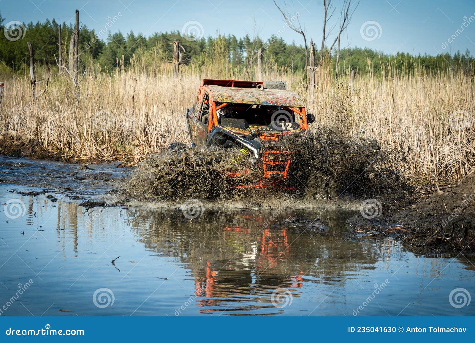 ATV and UTV Riding in Hard Track with Mud Splash. Amateur Competitions ...
