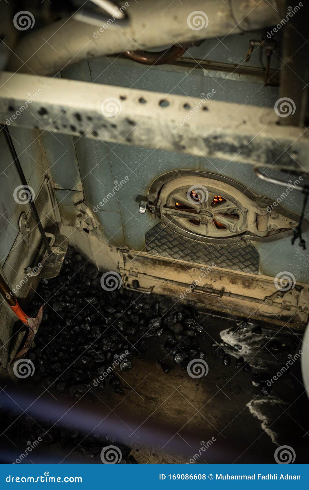 A Worker Insert a Coal Inside the Engine of Coaled Power Steam Ship ...