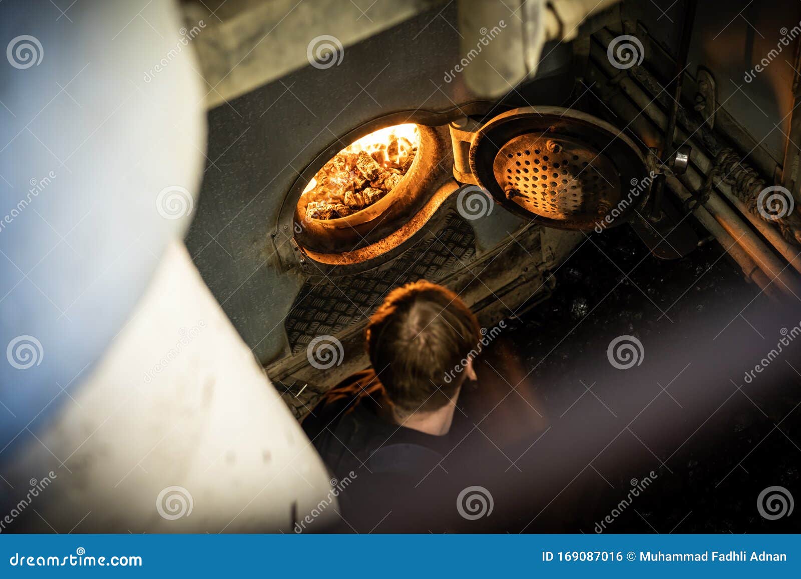 A Worker Insert a Coal Inside the Engine of Coaled Power Steam Ship ...